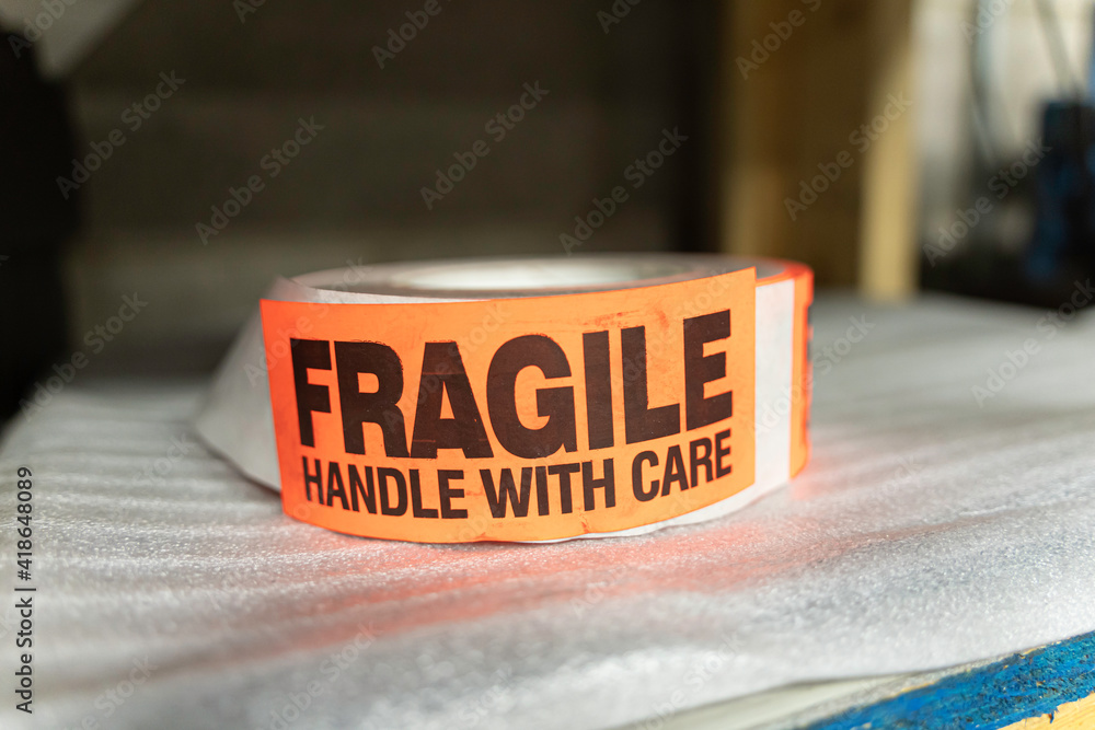 Orange colored shipping label for delivering fragile items Stock Photo ...