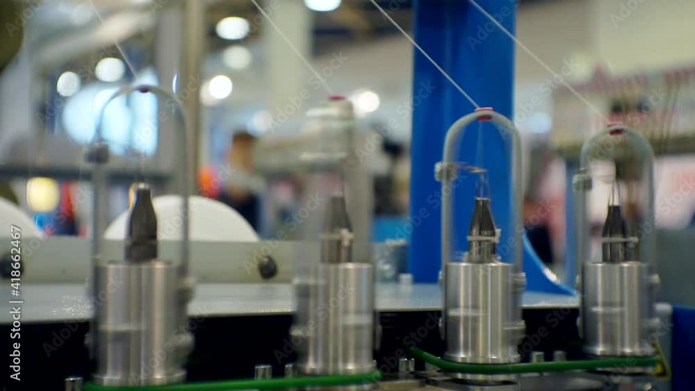 several threads are pulled through the rotating parts of the textile ...