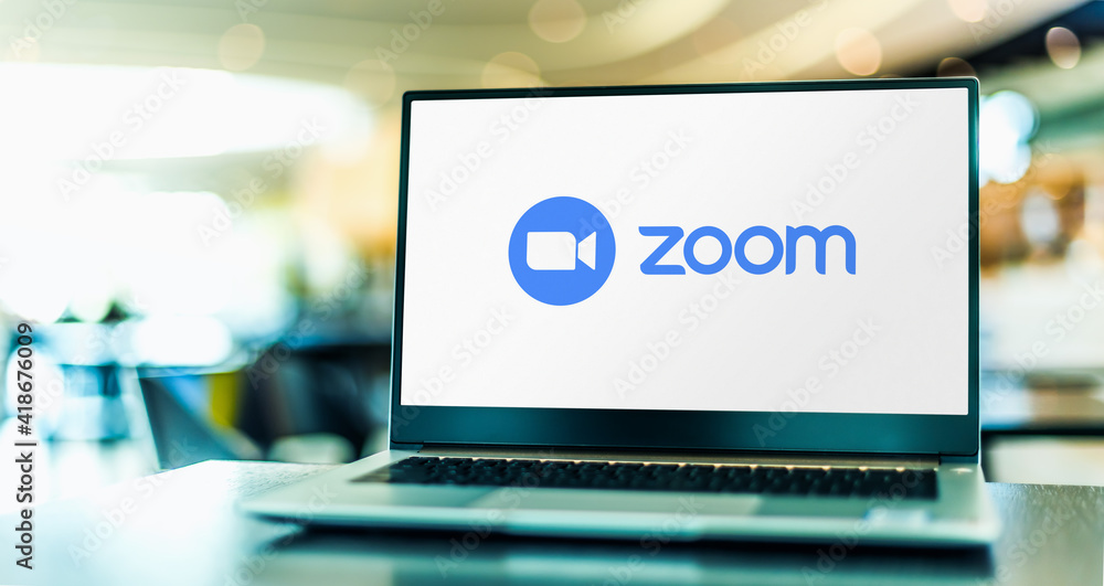 Laptop computer displaying logo of Zoom Stock Photo | Adobe Stock