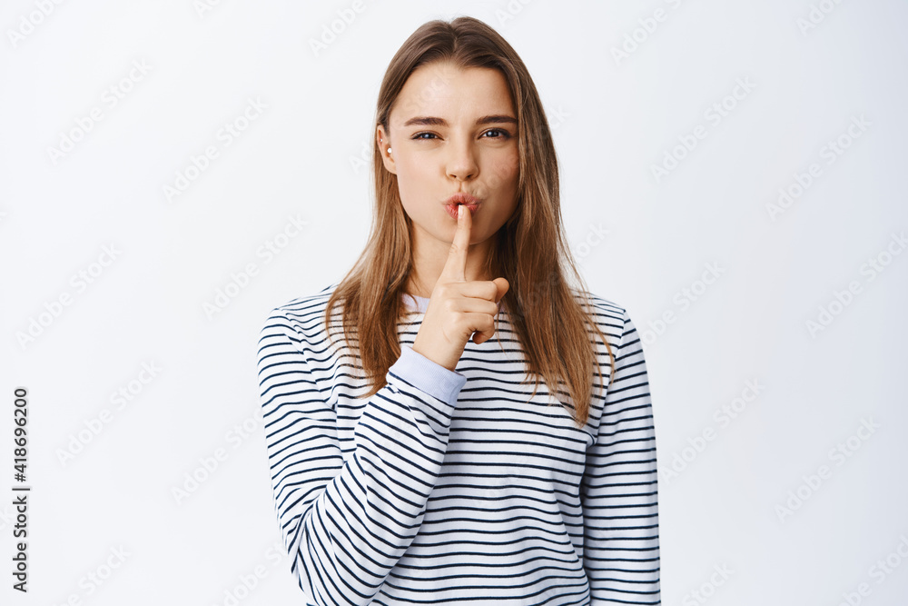 Image of young blond girl shushing at camera, telling a secret, asking ...