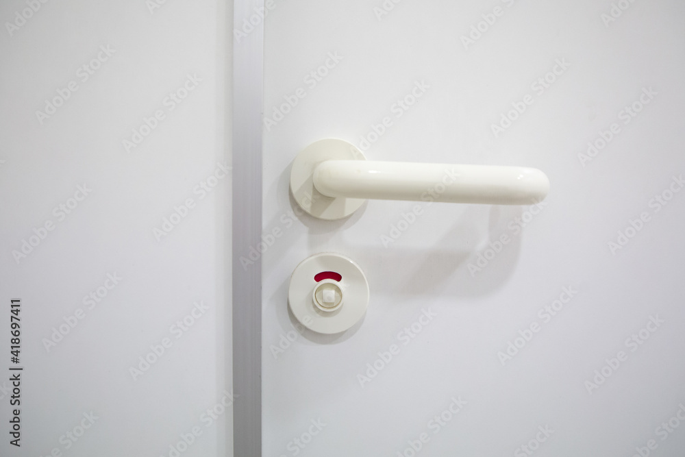 locked bathroom door with red sign shows someone is inside the cabin ...