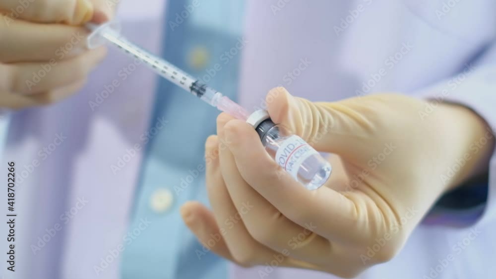 Female doctor talking to patient.doctor with syringe doing injection of ...