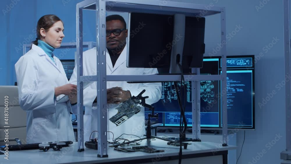 Diverse team of microelectronic engineers discuss current developments ...