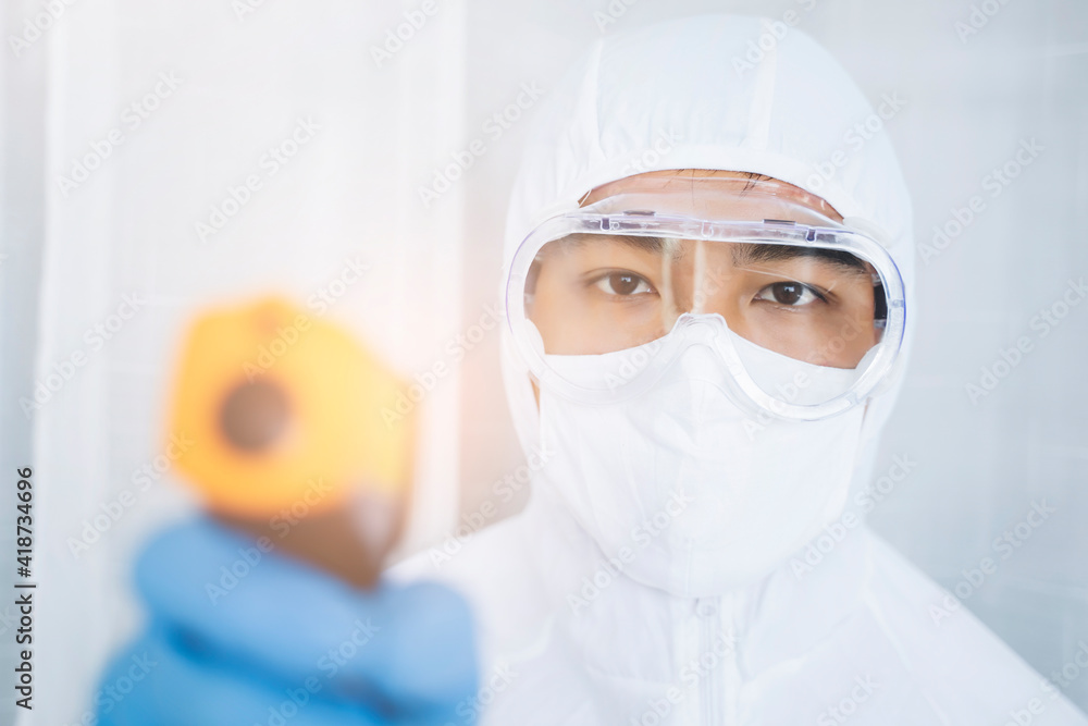 Medical healthcare scientist doctor using temperature thermal gun ...