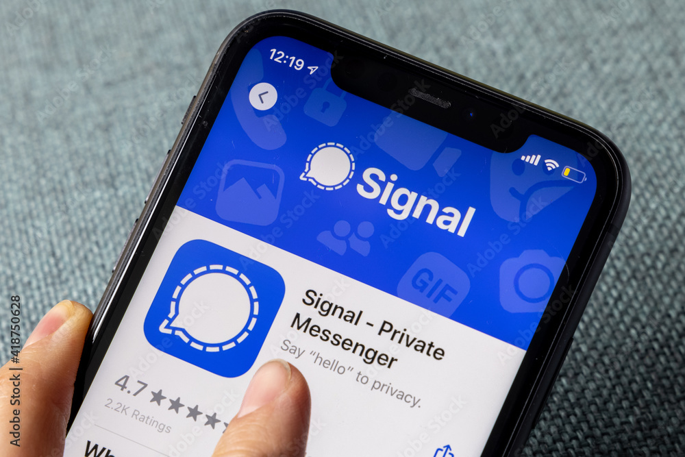 iPhone 11 on blue background with new messenger app Signal logo and ...
