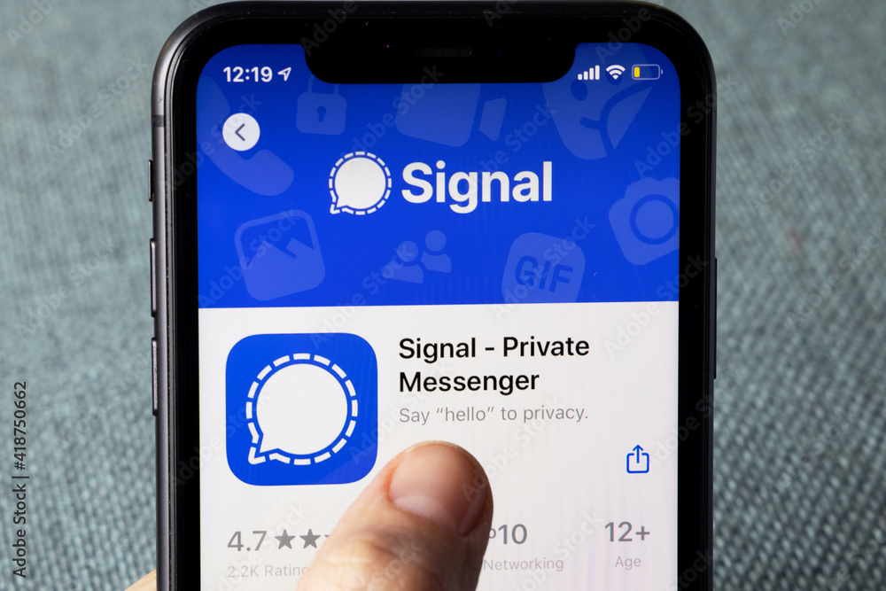 iPhone 11 on blue background with new messenger app Signal logo and ...