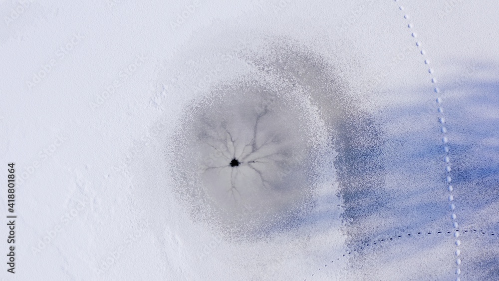 Round hole in a frozen lake. a natural hole from an underwater spring ...