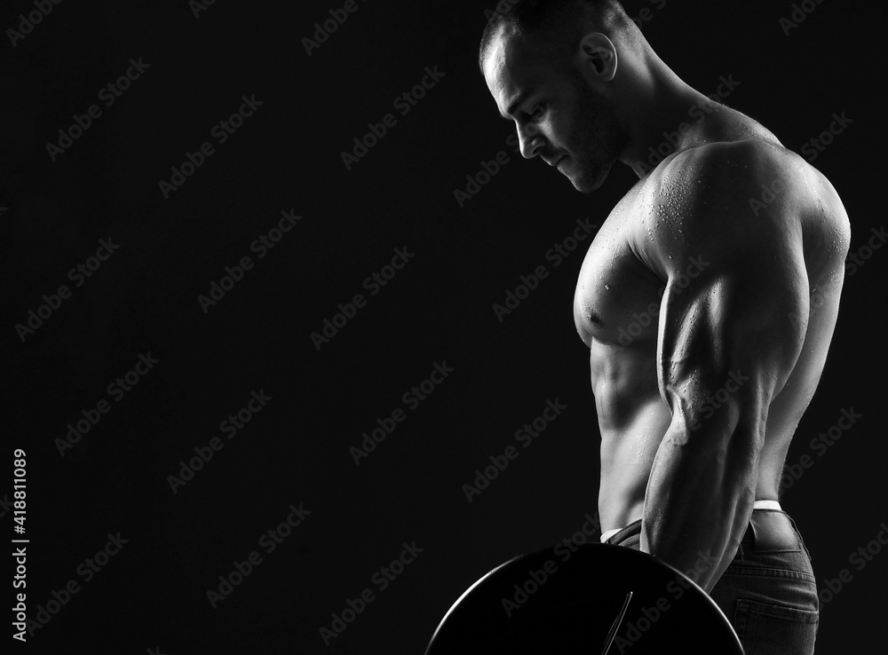Silhouette of Brutal strong man athlete in jeans lifting bar showing ...