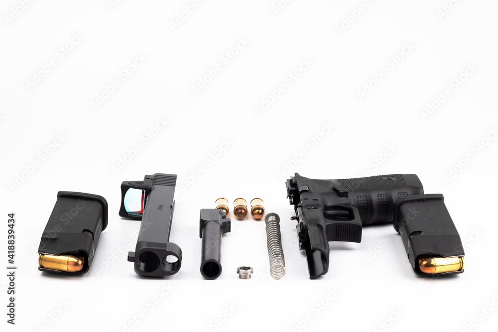 Parts of .45 semi automatic pistol handgun with bullets on white ...