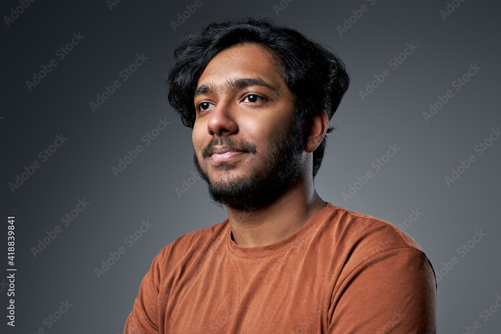 Closeup headshot of a indian guy with modern hairstyle in orange shirt ...
