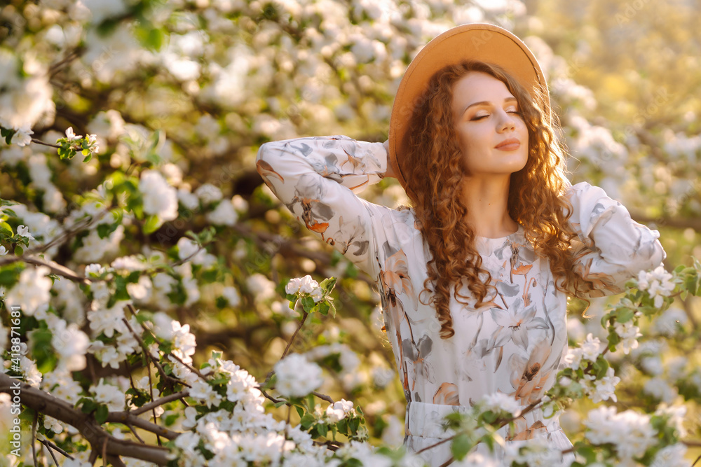 Spring beautiful romantic woman posing in blooming garden. The concept ...