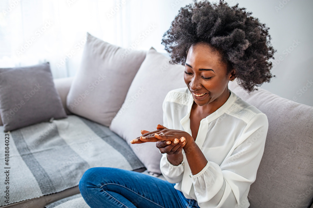 Young beautiful woman wearing wedding ring on finger, home background ...
