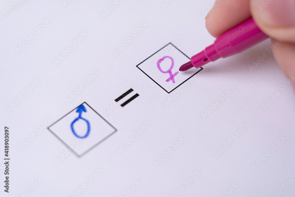 Gender Equality Concept. Hand with pink marker draws gender symbol of ...