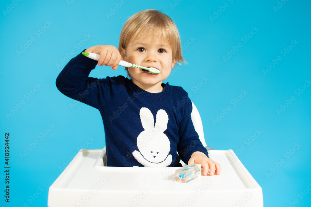 A little boy is learning to brush his teeth using a toothbrush. Concept ...