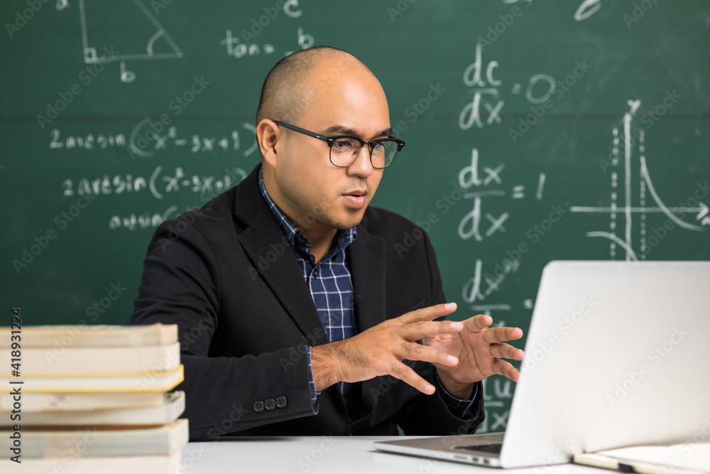 Indian young teacher man sitting teaching online video conference live ...