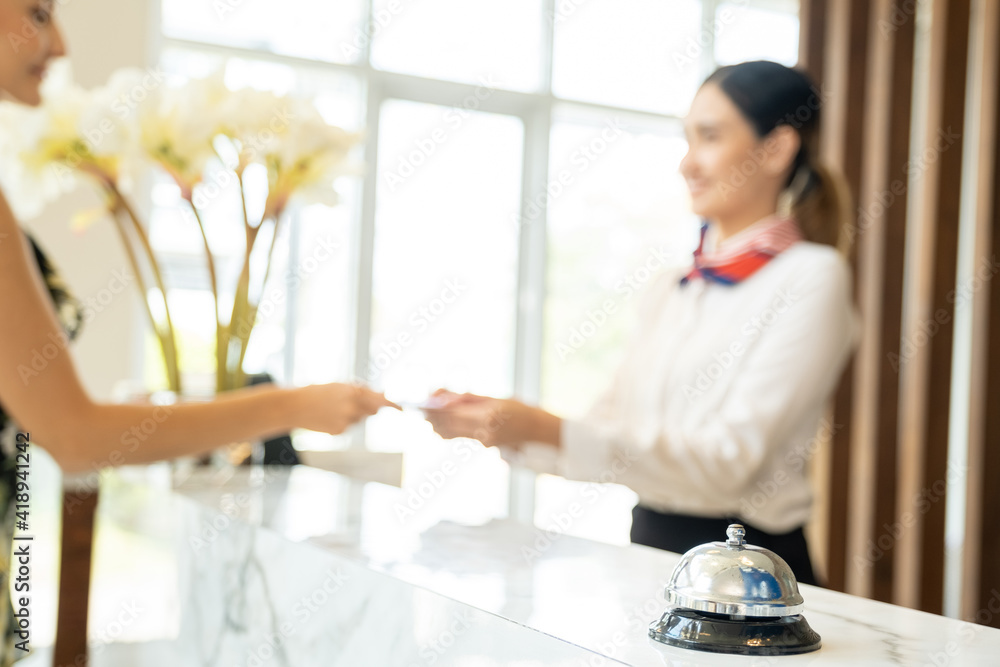 Close up bell in luxury modern reception hotel desk with the blurred ...