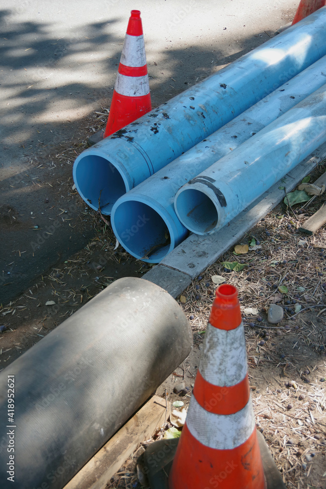 Blue plastic pipe and a black metal pipe for main water line ...