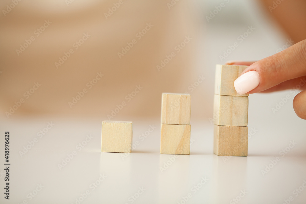 Woman hand putting and stacking blank wooden cubes on desk with copy ...