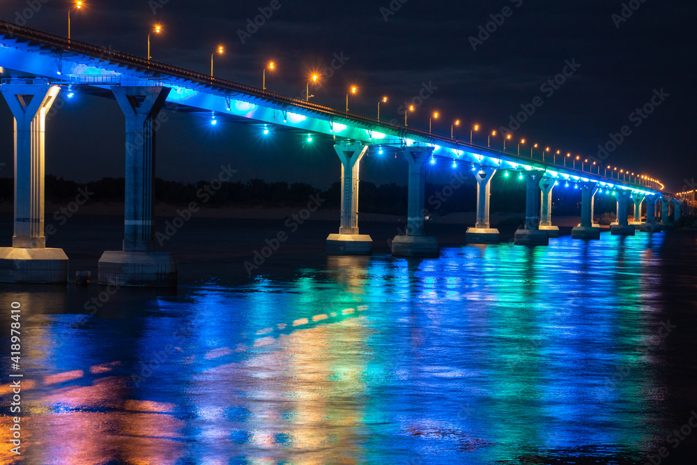 Poster Side view of colourful bridge illuminated with blue and green ...