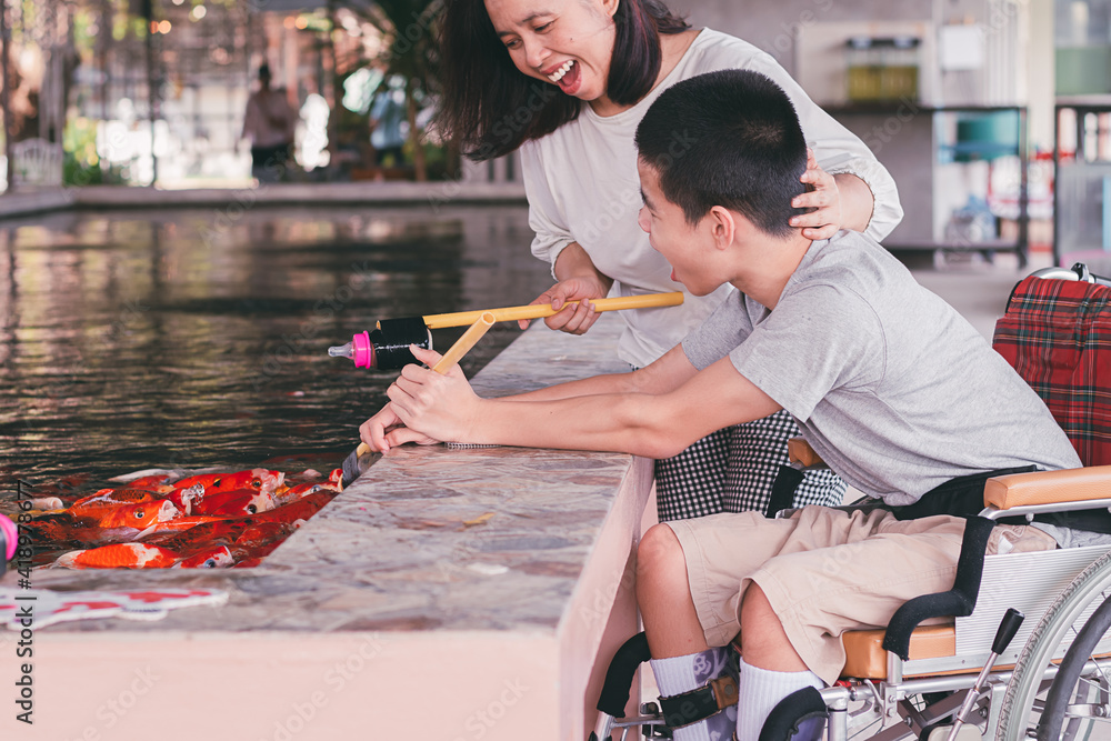 Asian disabled child on wheelchair doing activities in vacation time ...