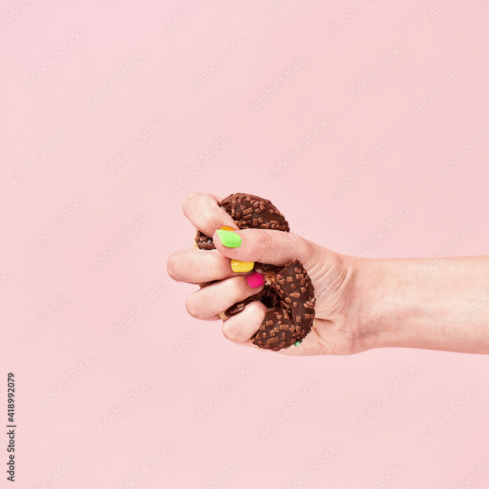 Junk Food. Say no to unhealthy food. Hand squeezing chocolate donut on ...