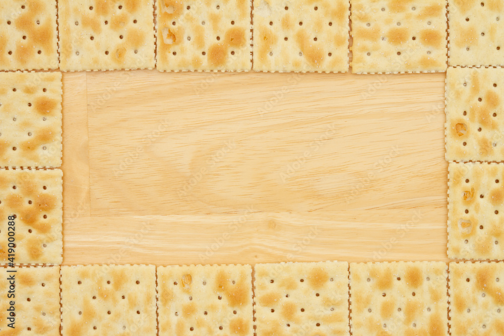 Saltine crackers border with wood background Stock Photo | Adobe Stock