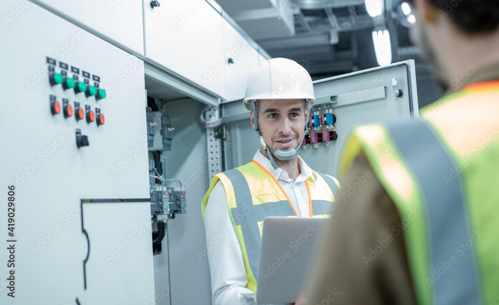 Electrician engineer tests electrical installations and wires on relay ...