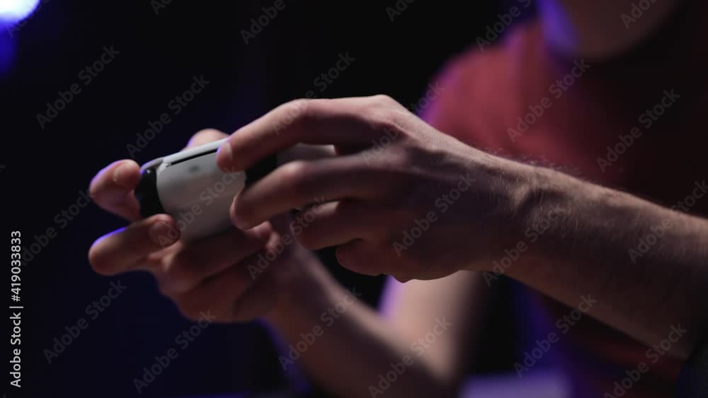 Playing video game console on tv. Hand hold new joystick. Gamer play ...