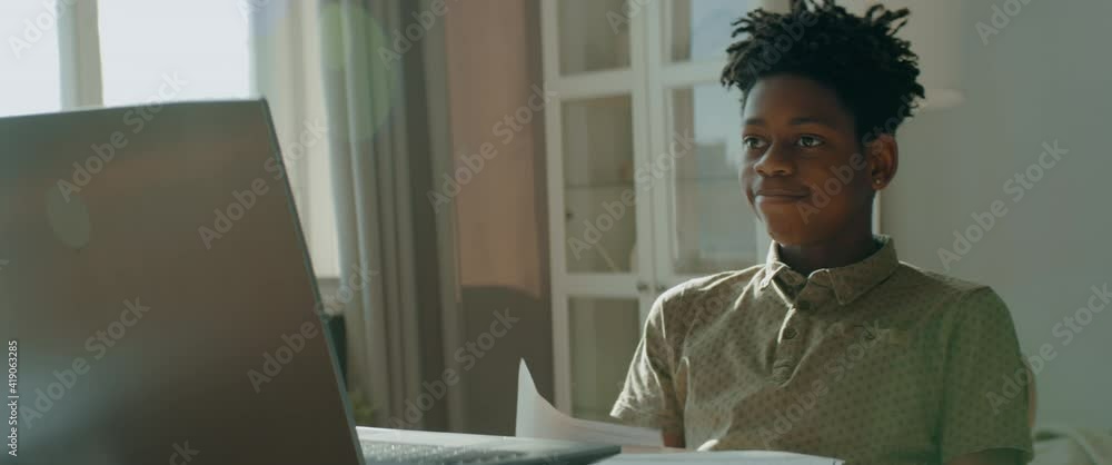 African American Black kid boy studying from home, having a video with ...