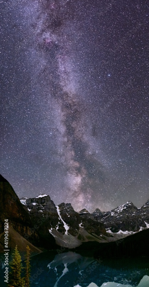Milky Way vertical panorama above Moraine lake in Canadian Rocky ...