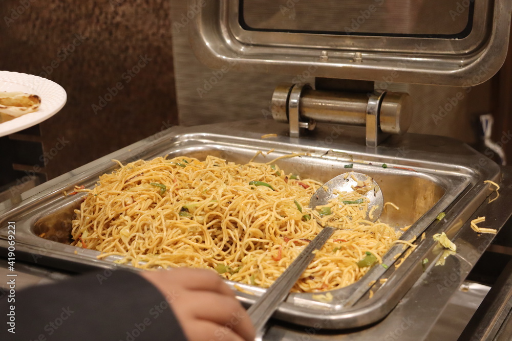 Buffet counter of the tasty Chinese food- Chow Mein noodles placed in ...
