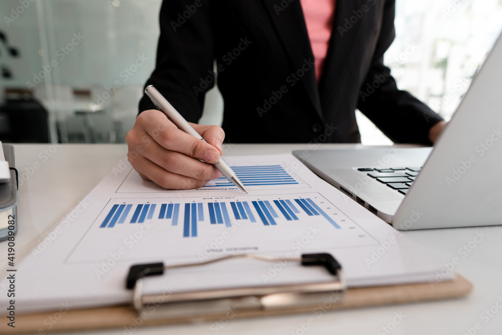 Business people checking charts, spreadsheets, graphs, financial ...