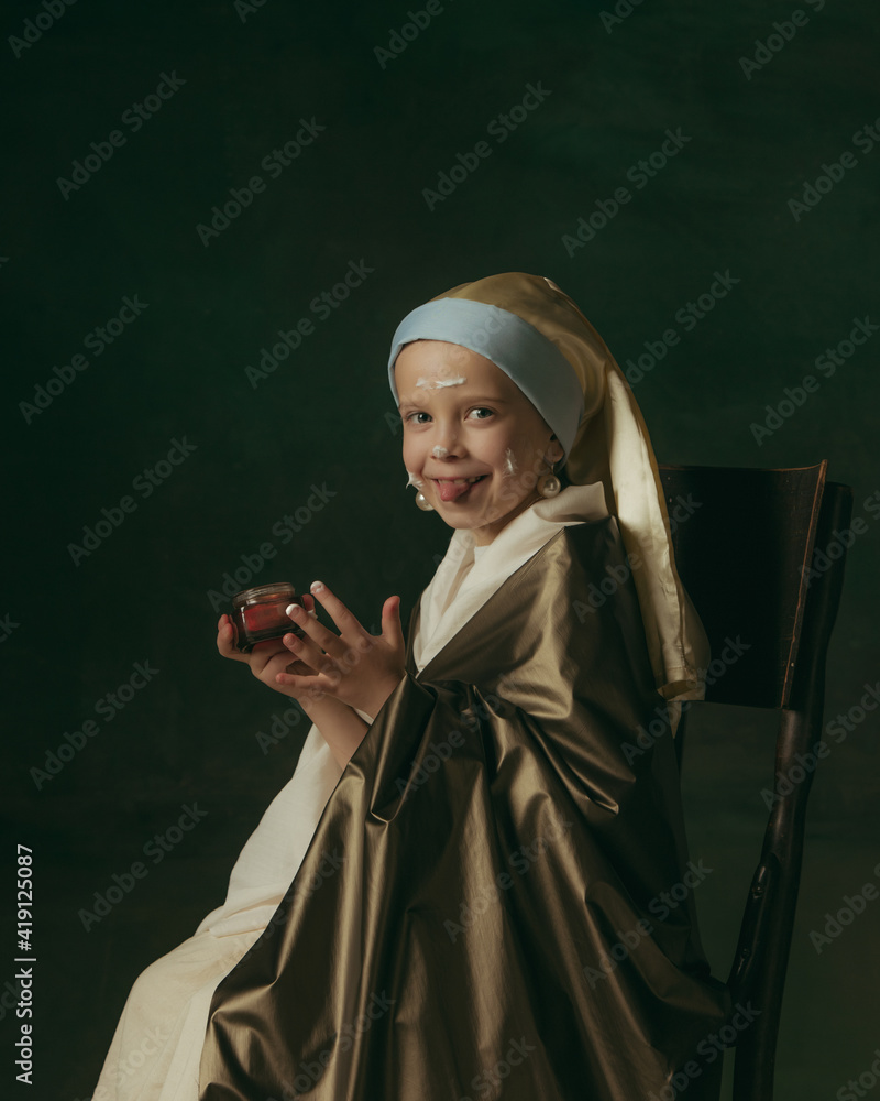 Using cosmetical face cream. Medieval little girl as lady with a pearl ...