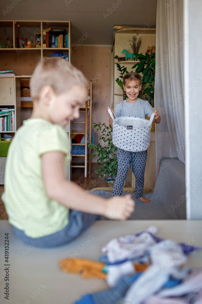 Household chores for children. Kids cleaning their room, sorting dry ...