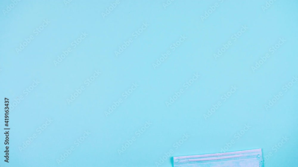 4k Masks, syringes and vaccine vials appear against a light blue ...