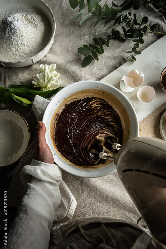 Step by step process of making chocolate cookies dough. beating ...