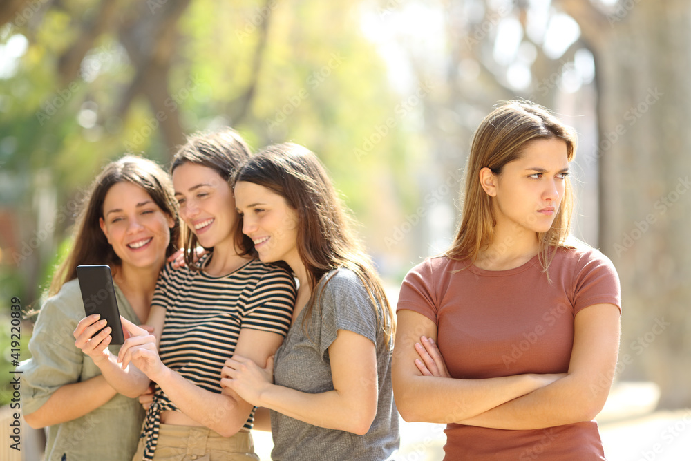 Angry woman being ignored by her friends in the street Stock Photo ...