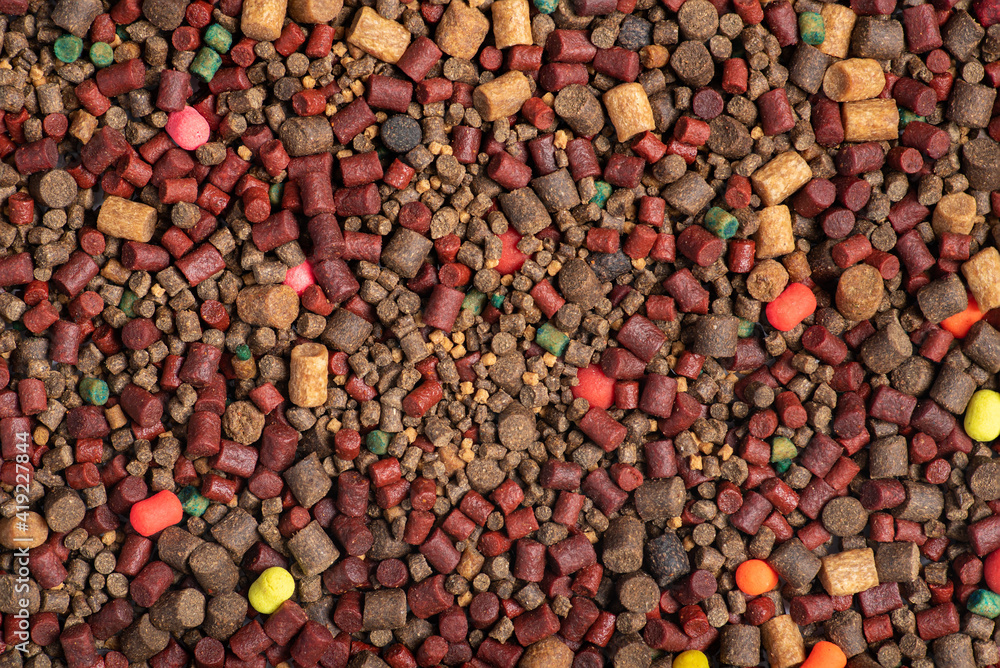 fishing bait pellet background with various types and sizes of fish ...
