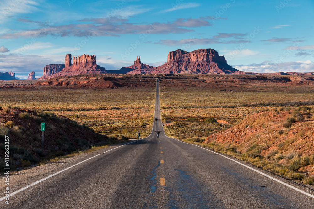 Open road of Route 163 with the Monument Valley on its background. The ...