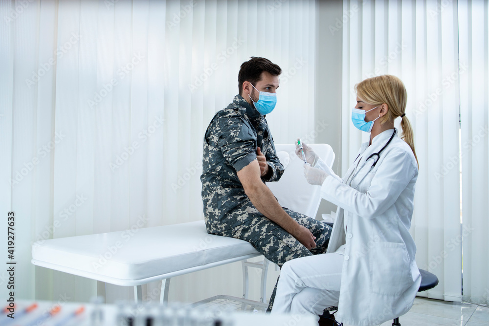 Vaccination of the military against corona virus. Soldier in uniform ...