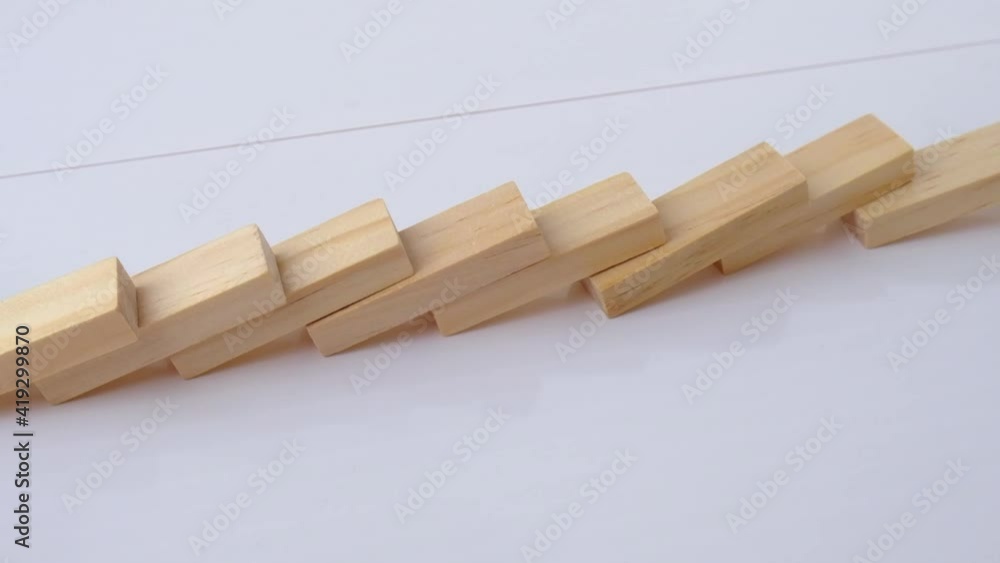 Vidéo Stock Domino effect, row of wooden domino falling down on white ...