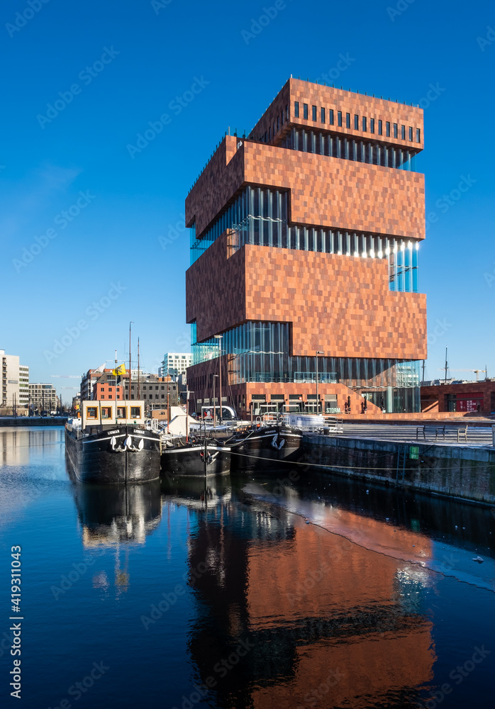 The famous MAS museum of Antwerp reflected in the Bonaparte dock Stock ...