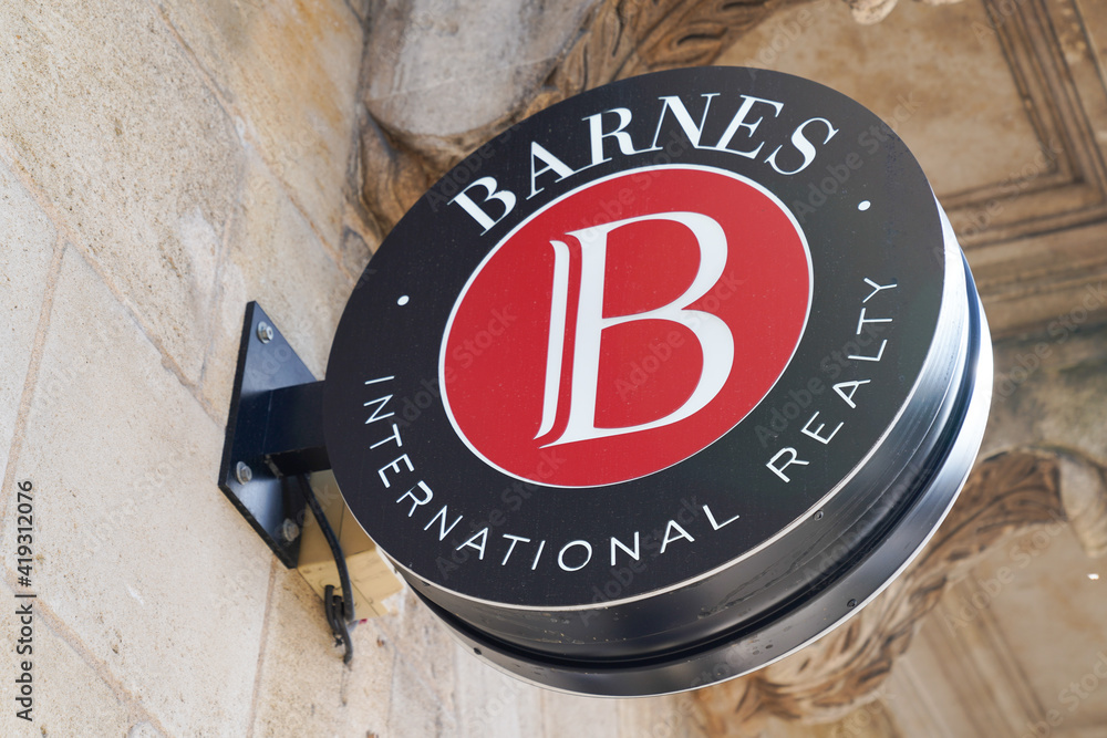 Barnes brand logo and sign front of office International Realty estate ...