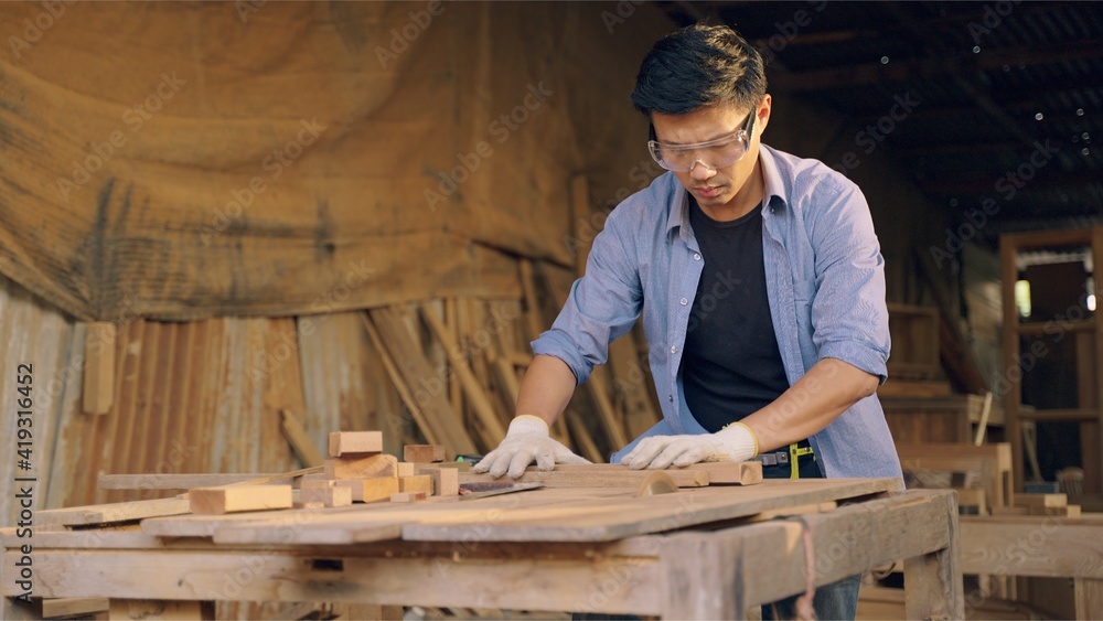 Professional asian carpenter working on wood craft in workshop to ...