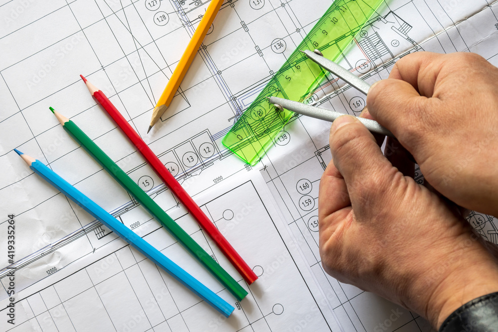 The draughtsman uses a compass to determine the size on the ruler. The ...