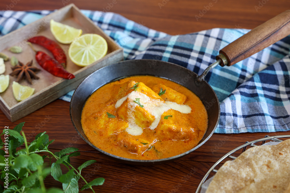 Paneer butter masala , pouring cream on Paneer tikka masala curry Delhi ...