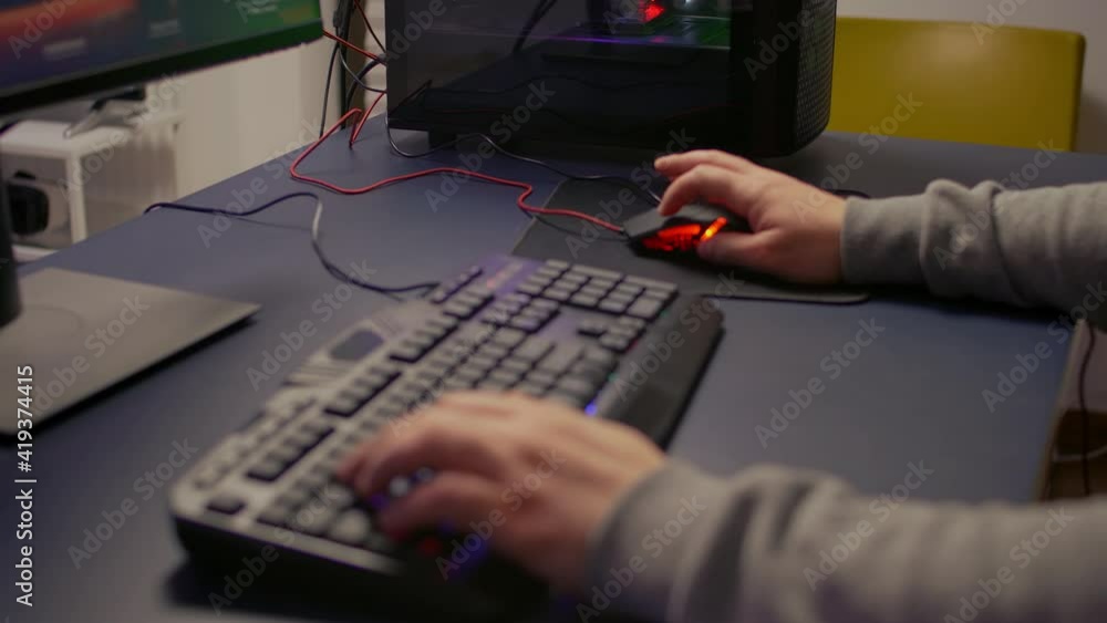 Closeup of player hands using RGB keyboard in gaming home studio ...