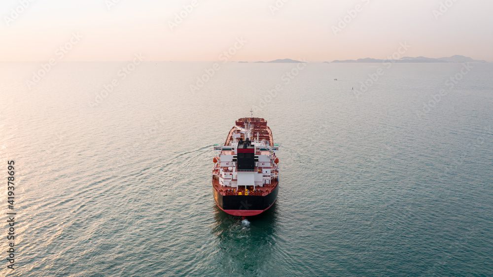 Aerial angle rear view of oil tanker ship sailing on open sea. Crude ...