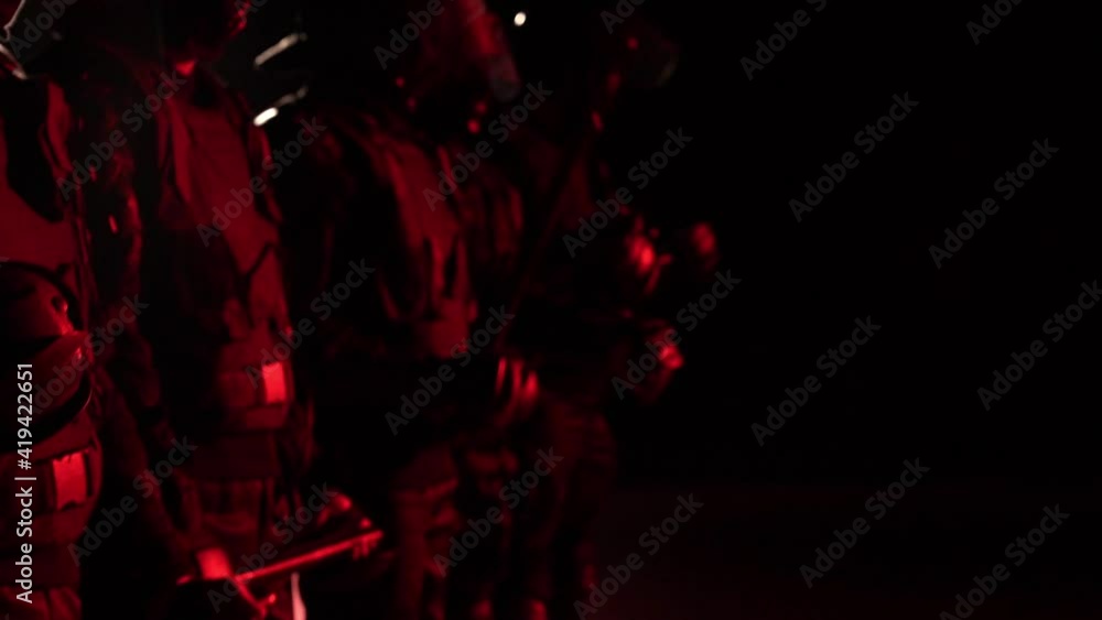 Special forces soldiers in black uniform and helmets on black ...