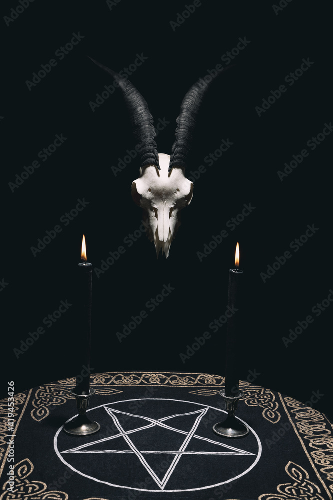 Witchcraft composition with goat skull, candles and pentagram symbol ...